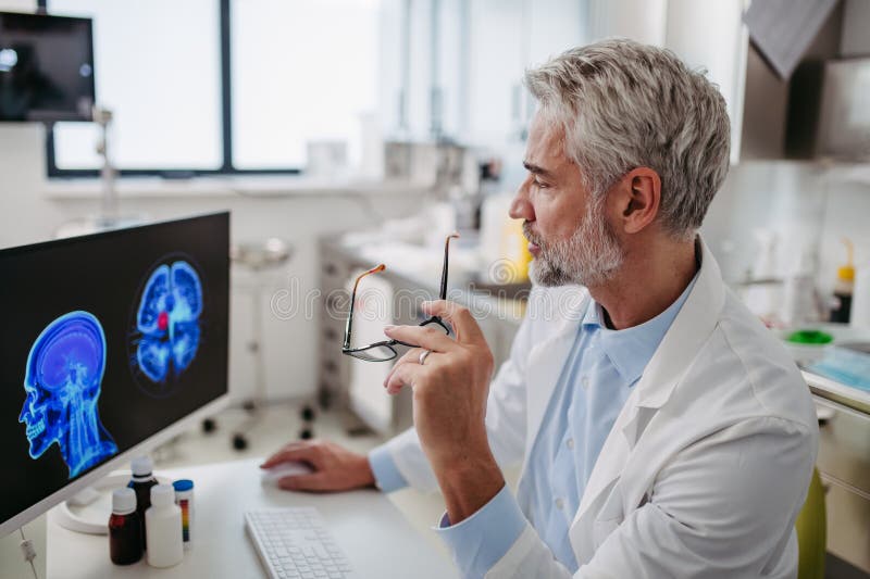 Doctor Looking at an MRI Scan, Patient S Test Results in Computer ...