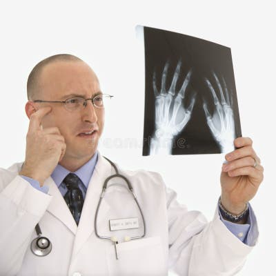 Doctor looking at xrays. stock photo. Image of baffled - 2425994