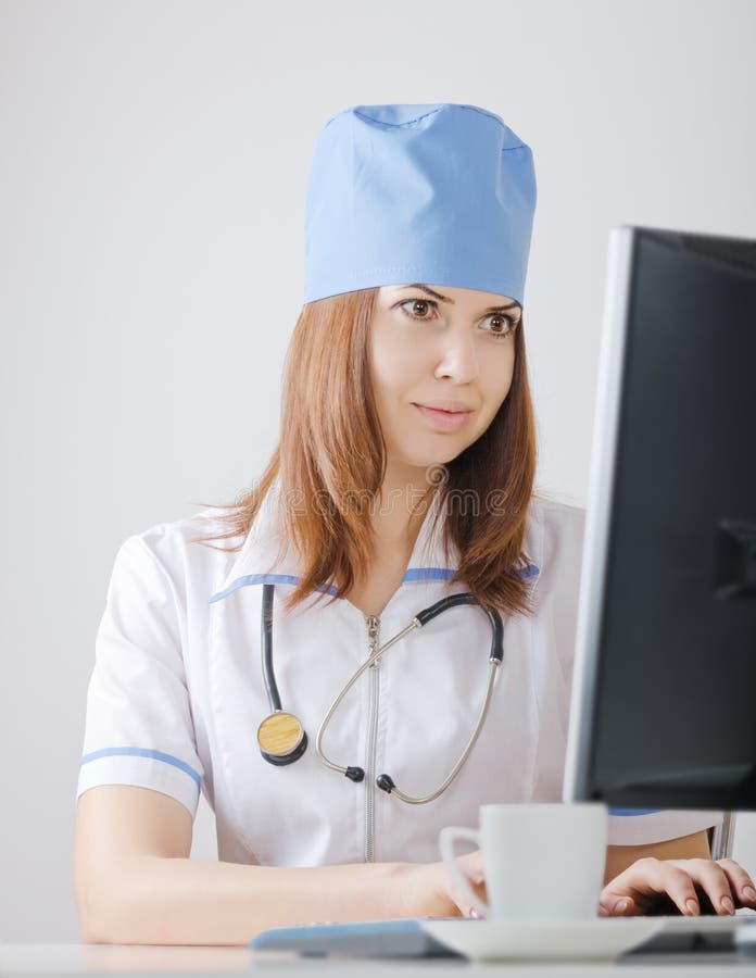 Doctor Looks at a Computer Monitor Stock Photo - Image of doctor ...