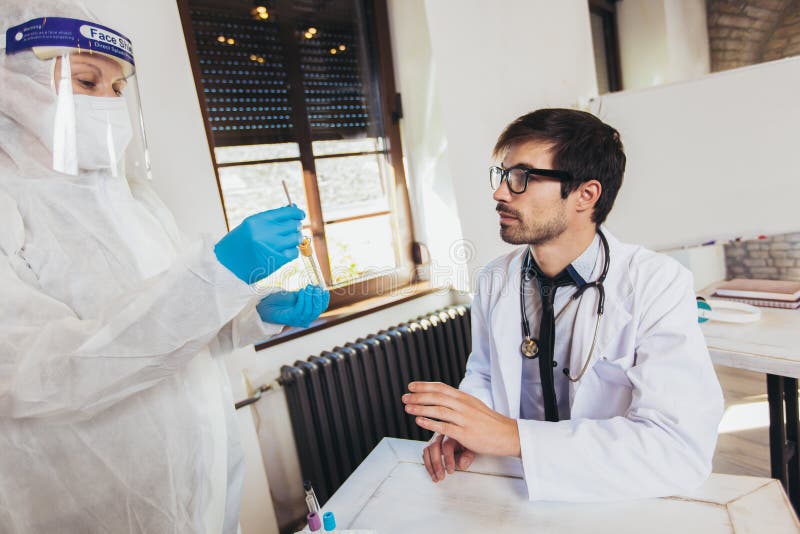 Doctor Making Covid-19 PCR Test for Her Colleague in Office Stock Photo ...
