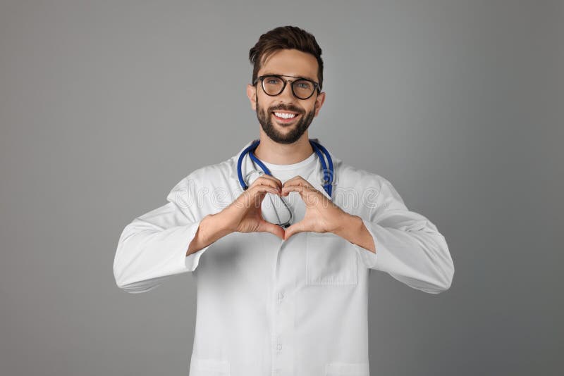 Doctor Making Heart with Hands on Grey Background Stock Image - Image ...