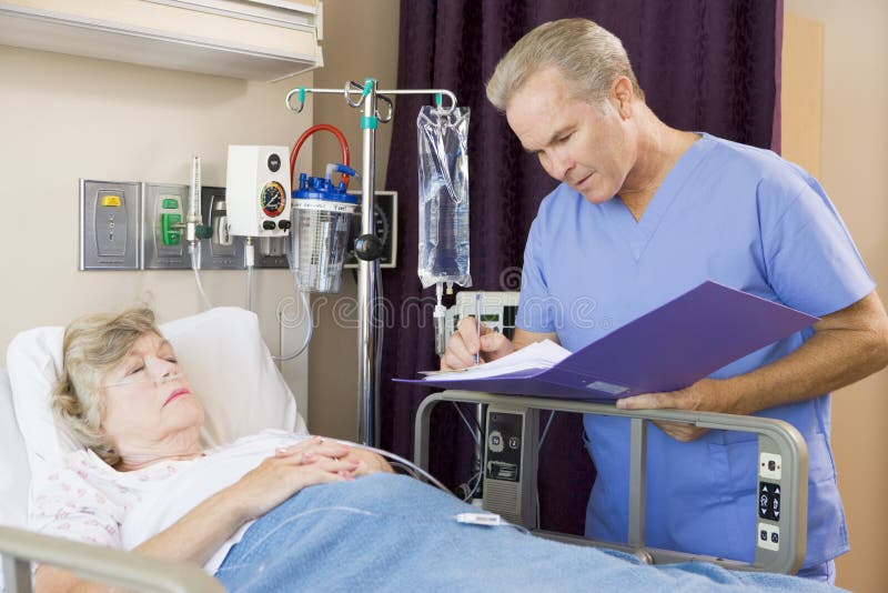 Doctor Making Notes about Patient Stock Image - Image of caring, colour ...