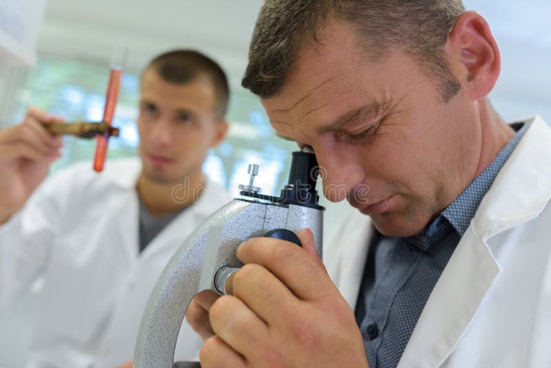 Doctor man with microscope stock image. Image of examine - 174514155