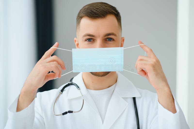 Doctor Man Puts on a Protective Mask Stock Photo - Image of person ...