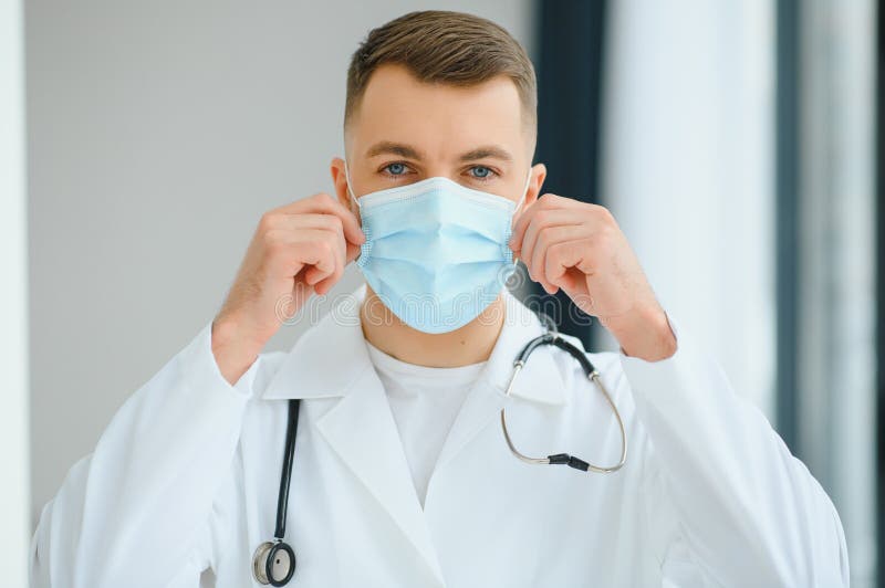 Doctor Man Puts on a Protective Mask Stock Photo - Image of clinical ...