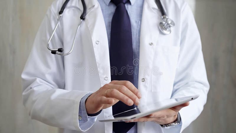 Doctor Man Wearing Lab Coat and Stethoscope Using Tablet Computer in ...