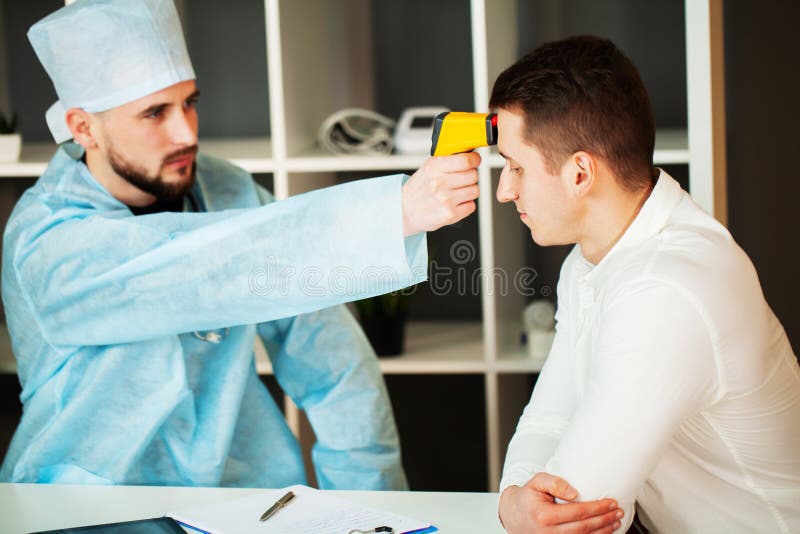 Doctor Measures the Patient`s Temperature in the Clinic Stock Image ...