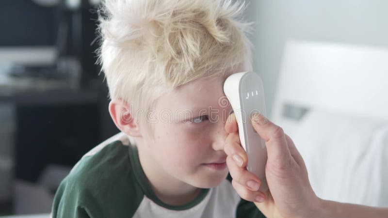 The Doctor Measures the Temperature of a Sick Boy with an Electronic ...