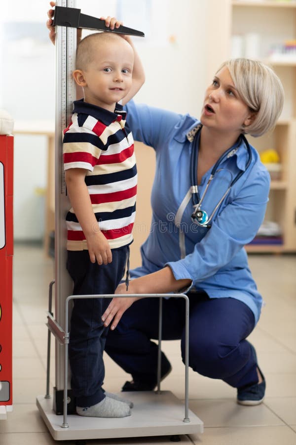 Doctor Measuring Girl`s Height Stock Photo - Image of childhood ...