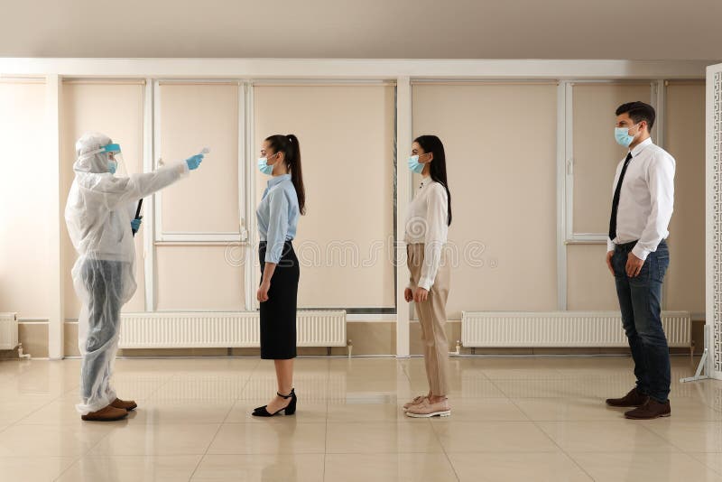 Doctor Measuring Employees Temperature in Office. Prevent Spreading of ...