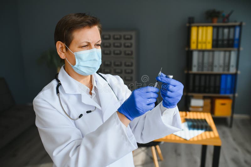 Doctor with Medical Syringe in Hands, Getting Ready for Injection Stock ...