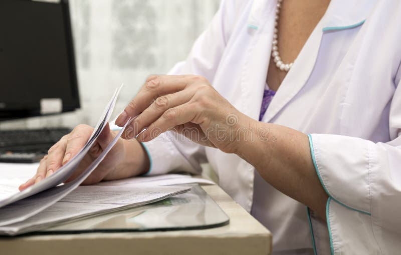 Doctor, Medical Worker in a White Coat Examines the Table Documents ...