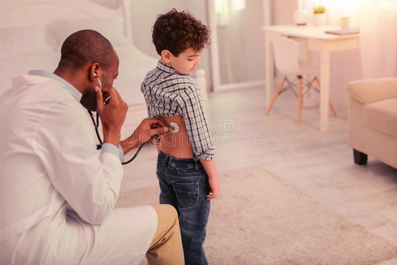 Doctor Meticulously Examining Child Having Breathing Problems Stock ...