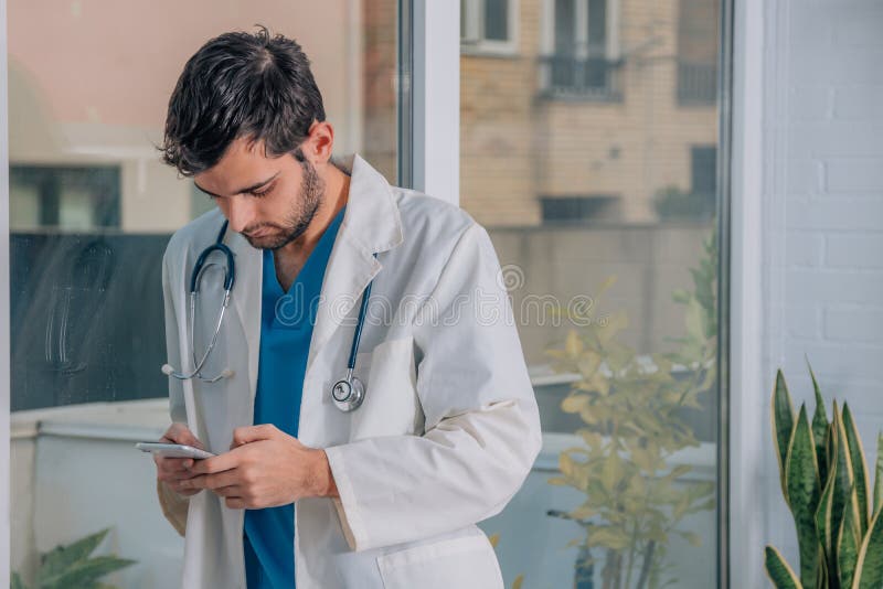 Doctor with mobile phone stock image. Image of modern - 243089451