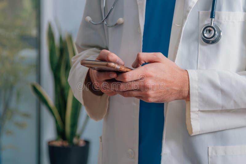 Doctor with mobile phone stock photo. Image of modern - 243089402