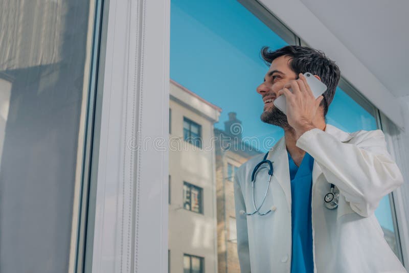 Doctor with mobile phone stock image. Image of hospital - 243089441