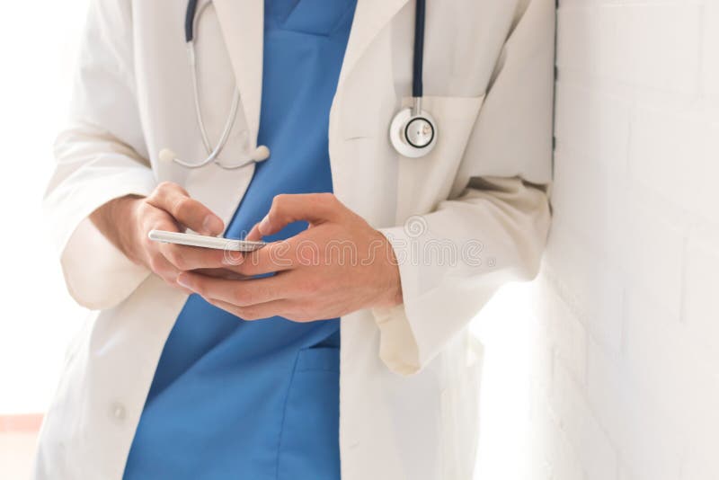 Doctor with mobile phone stock photo. Image of asian - 161748398