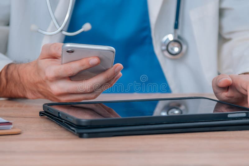 Doctor with Mobile Phone and Tablet Stock Photo - Image of laptop ...