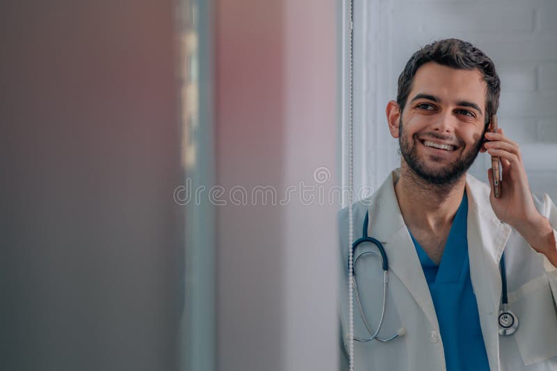 Doctor with mobile phone stock image. Image of call - 243089421