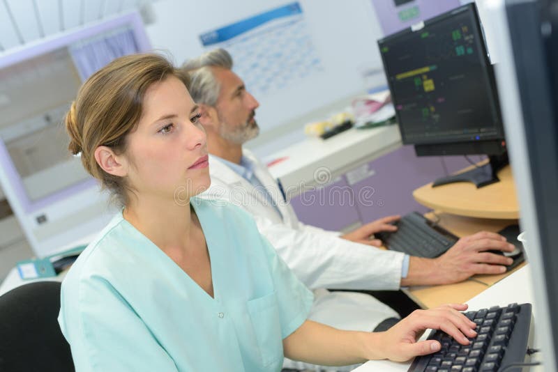 Doctor and Nurse Checking Computers Stock Photo - Image of holding ...
