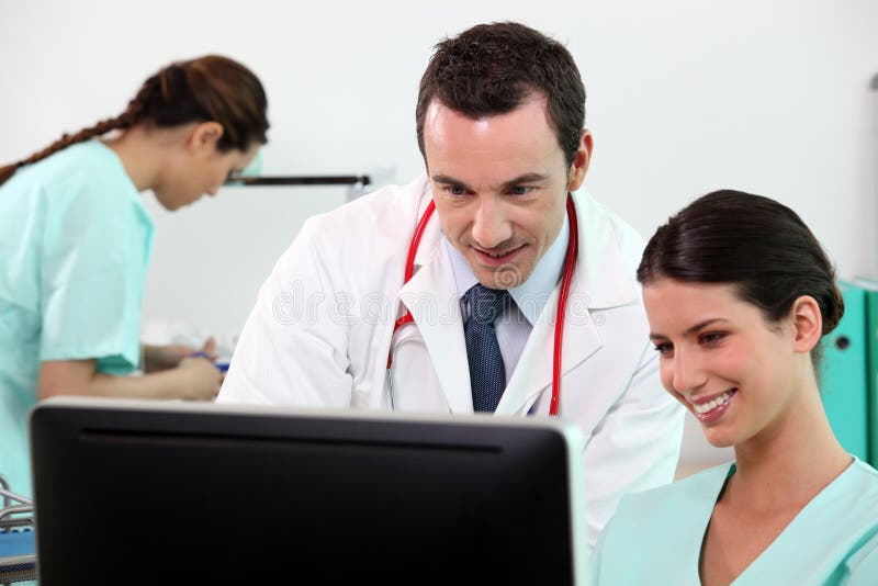 Doctor and Nurse at a Computer Stock Image - Image of occupation ...