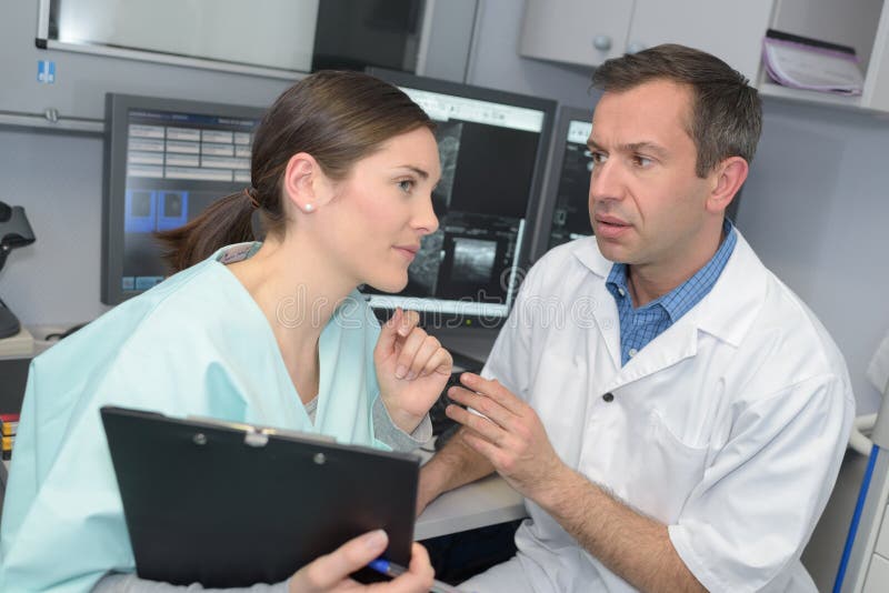 Doctor and Nurse Concerned about Patients Case Stock Image - Image of ...