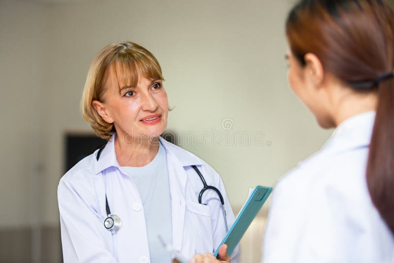 Doctor and Nurse Discuss and Check Patient Data in Hospital Stock Image ...