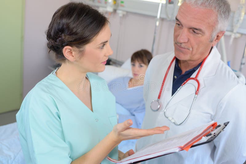 Doctor and Nurse in Discussion at Patient S Bedside Stock Image - Image ...