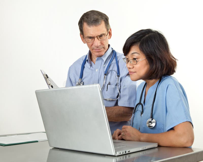 Doctor and Nurse Reviewing on Laptop Computer in O Stock Photo - Image ...