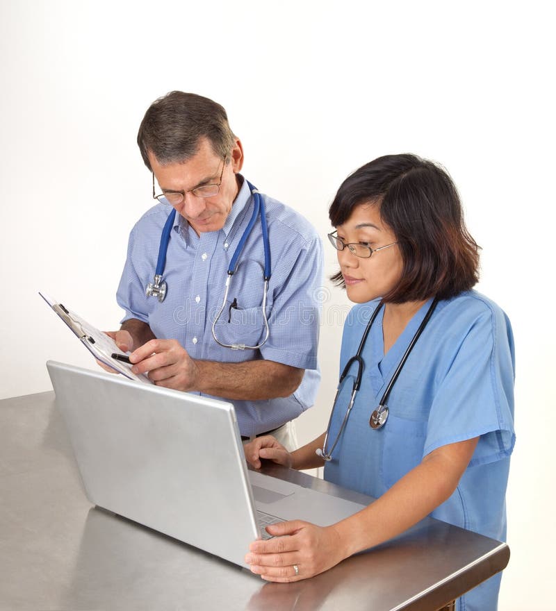Doctor and Nurse Reviewing on Laptop Computer in O Stock Photo - Image ...