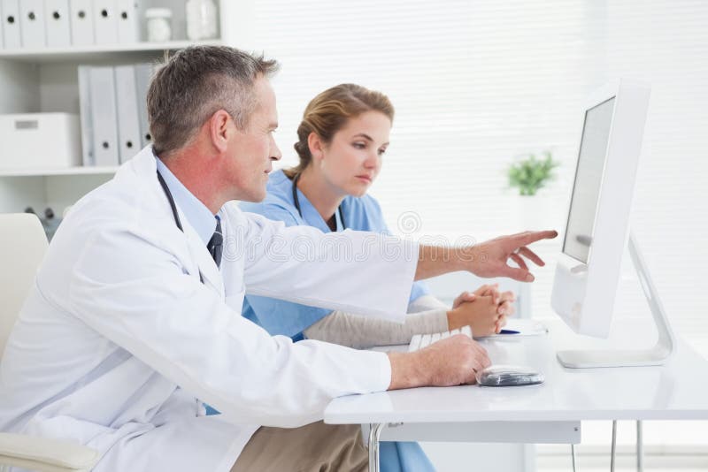 Doctor and Nurse Looking at a Computer Stock Image - Image of adult ...