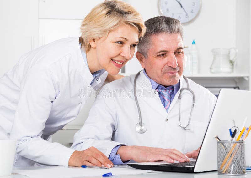 Doctor and Nurse Reading Information Stock Image - Image of american ...