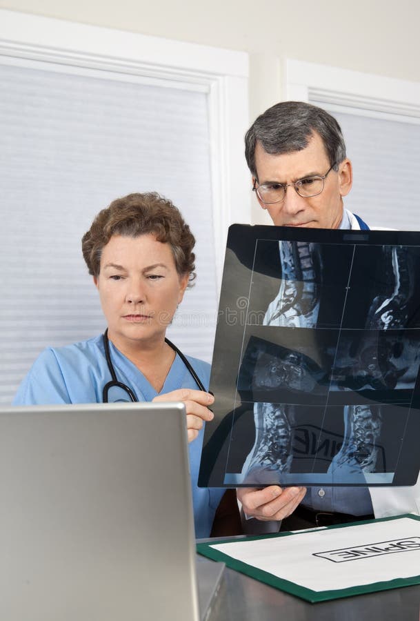 Doctor and Nurse Reading Spinal MRI Scan Stock Photo - Image of laptop ...