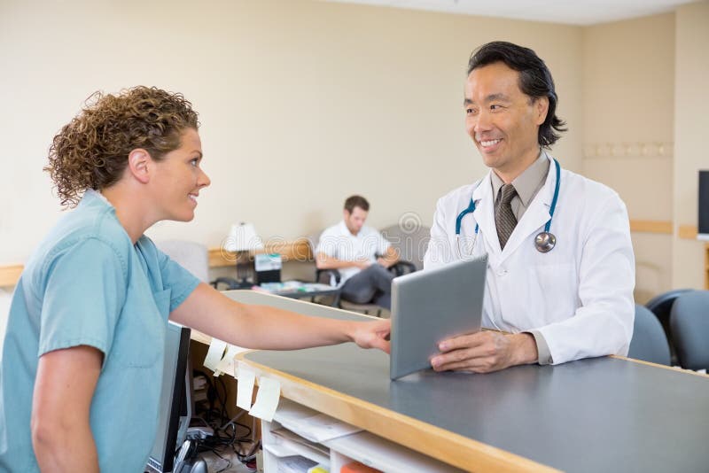 Nurse Using Digital Tablet while Doctor and Stock Image - Image of blue ...