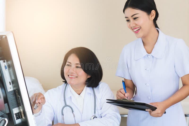 Doctor and Nurse Working on Computer in Medical Office Stock Image ...