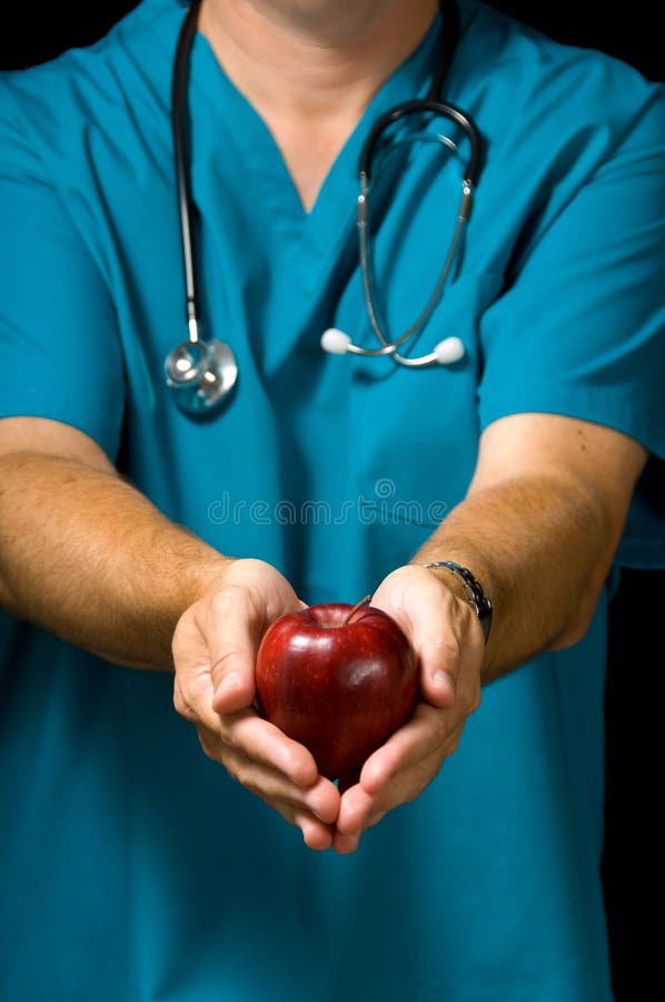 Doctor offering apple stock photo. Image of stethoscope - 2889936