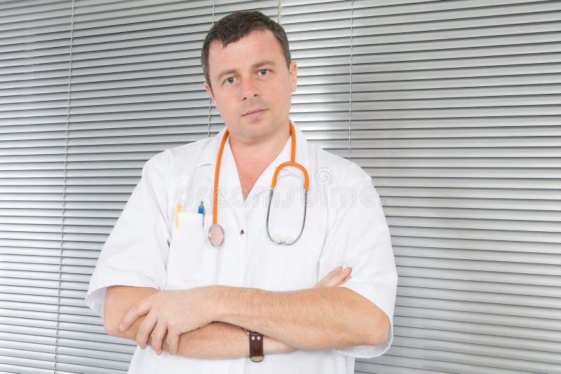 Doctor in Office Arms Cross with Orange Stethoscope Stock Photo - Image ...