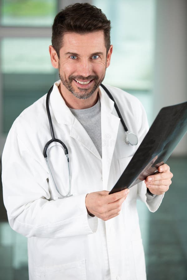 Doctor in Office Looking at Xray Results Stock Photo - Image of ...