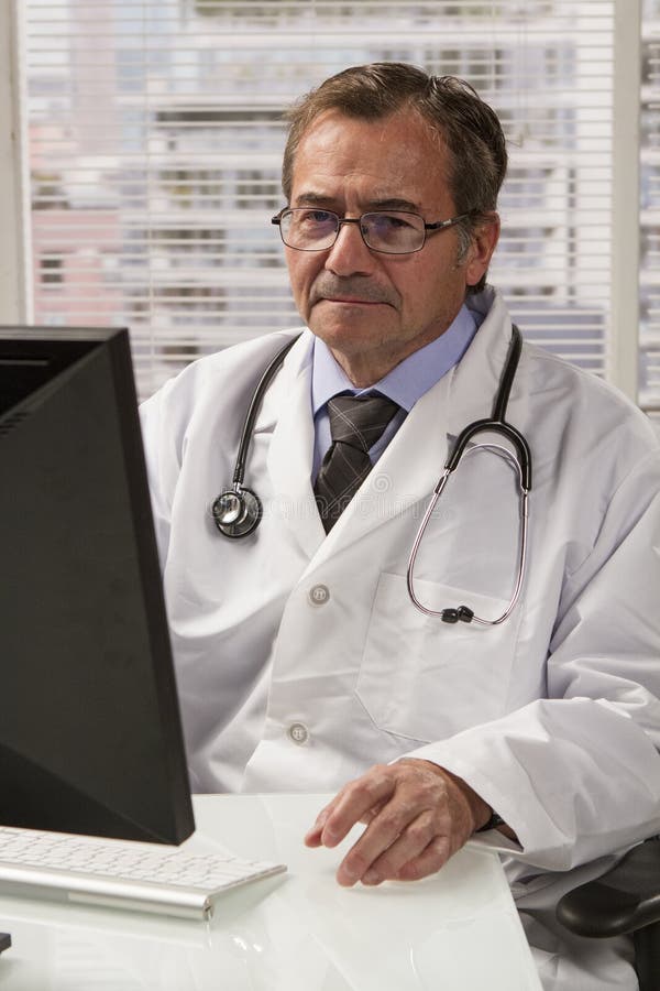 Doctor in Office Using Computer, Vertical Stock Image - Image of ...