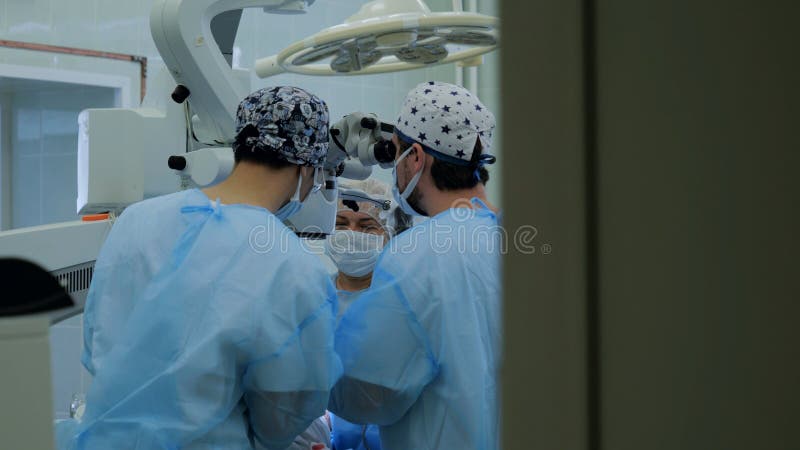 The Doctor Operates Using a Microscope during Nerve Surgery. the ...