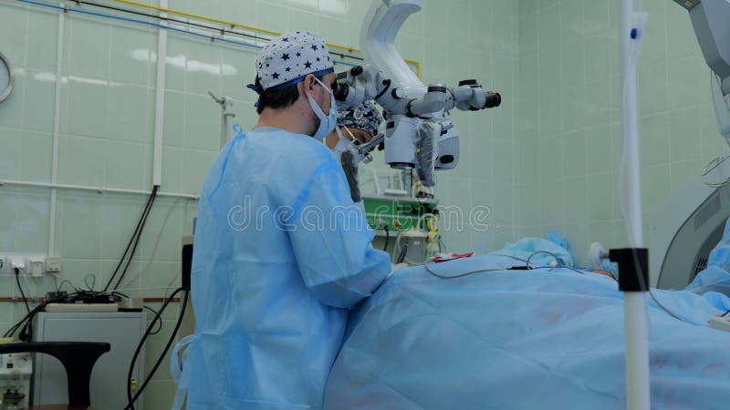 The Doctor Operates Using a Microscope during Nerve Surgery. the ...