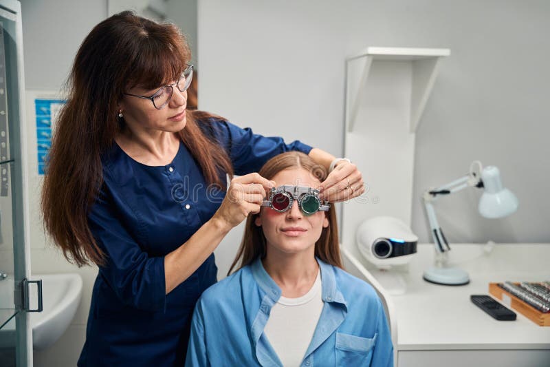 Doctor Optometrist Fitting Trial Frame on Patient during Eye Exam Stock ...