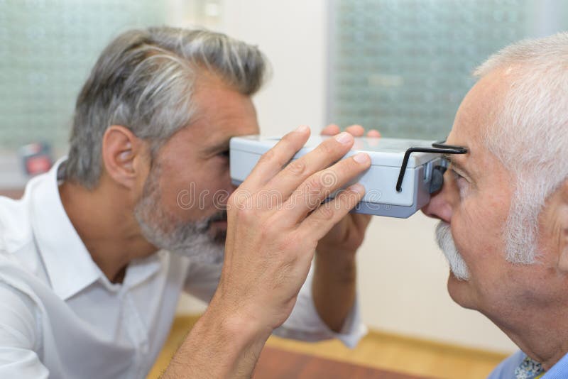 Doctor Optometrist at Work with Device for Testing Vision Stock Photo ...
