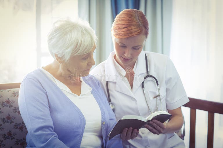 Doctor and Patient Reading a Book Stock Photo - Image of clothing, aged ...