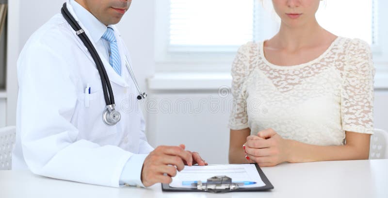Doctor and Patient Talking while Sitting at the Table . Concept of ...