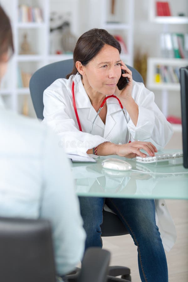 Doctor on Phone Calling Analyzes Centre with Patient Stock Image ...