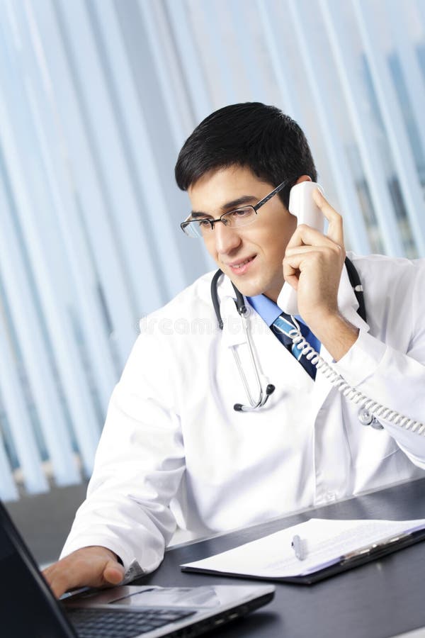 Doctor calling on phone stock image. Image of computer - 8377815