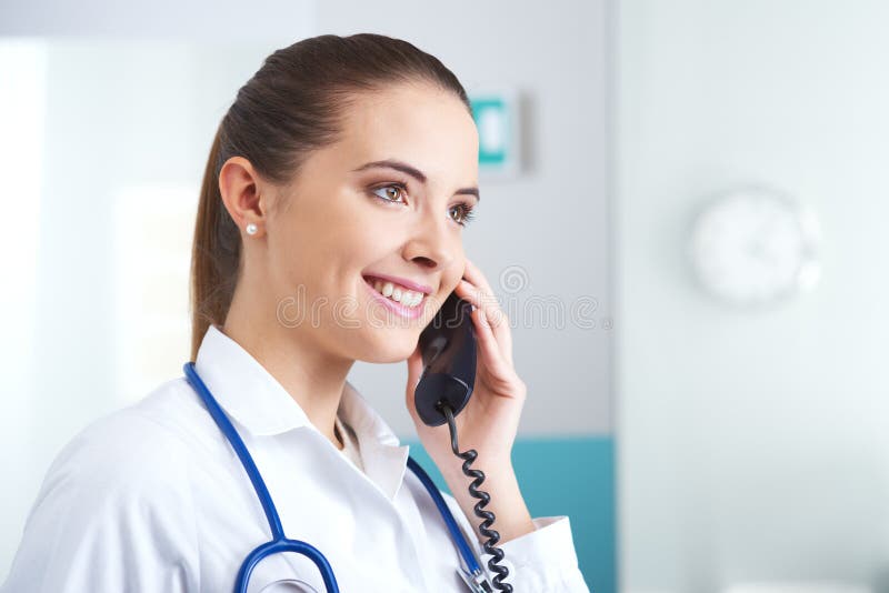 Doctor Talking on Telephone while Using Digital Tablet Stock Image ...