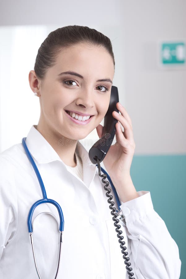 Doctor at phone stock photo. Image of healthcare, scrubs - 44562512
