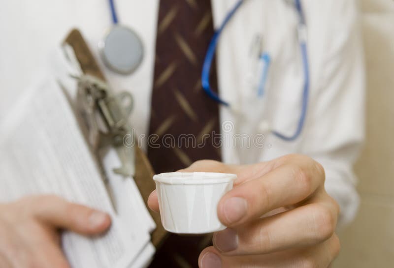 Doctor with pills in cup_5 stock image. Image of dispensing - 6815085
